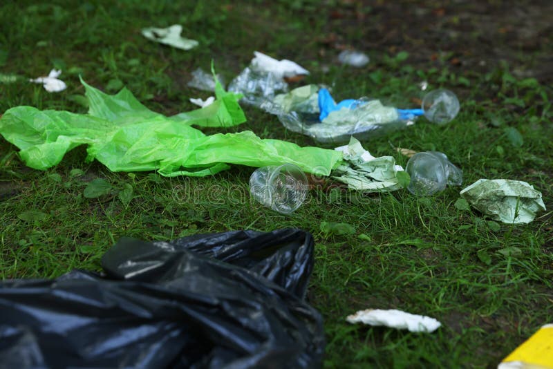Different Garbage Scattered on Green Grass Outdoors Stock Photo - Image ...