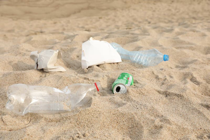 Different Garbage Scattered on Sand. Recycling Problem Stock Photo ...