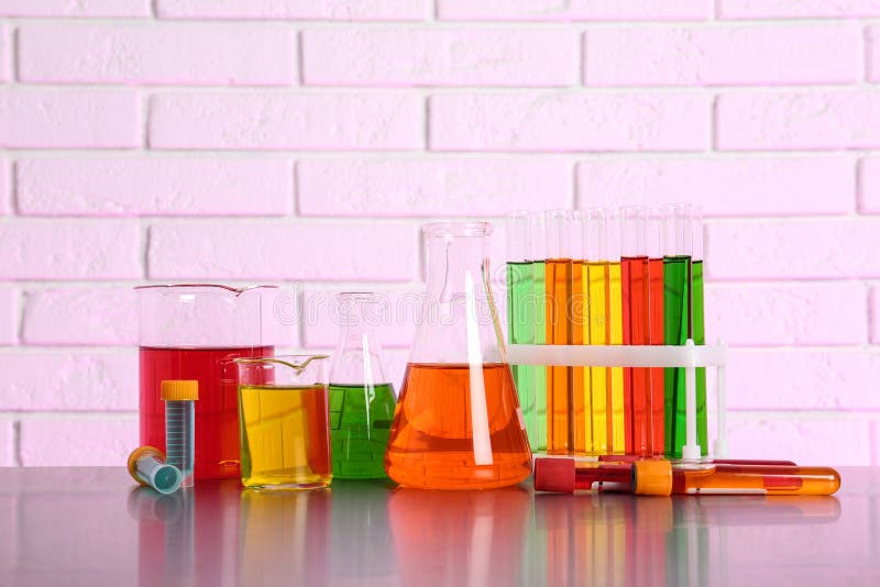 Different Glassware with Samples on Table Near Brick Wall Stock Photo ...