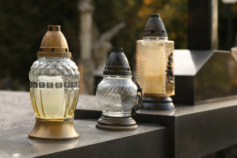 Different Grave Lanterns on Granite Tombstone Outdoors, Space for Text ...