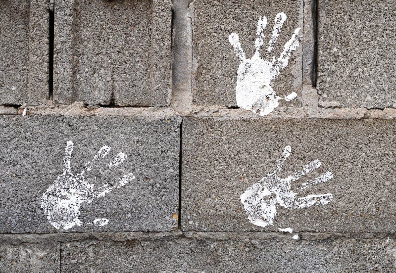 Different Hand Prints Made with White Paint on a Wall Stock Image ...