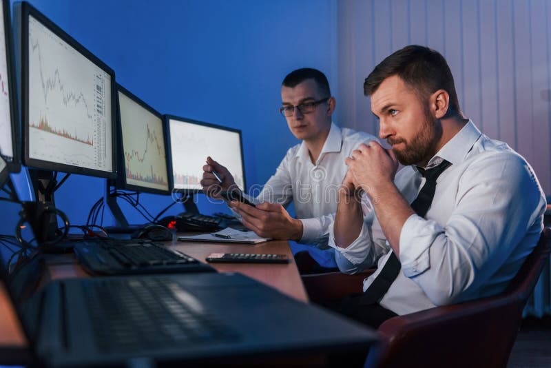 Different Information on Screens. Two Stock Traders Working in the ...