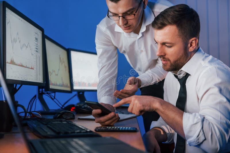 Different Information on Screens. Two Stock Traders Working in the ...