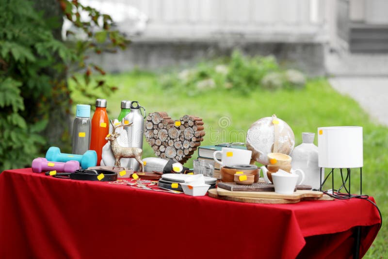 Different Items on Table in Yard. Garage Sale Stock Photo - Image of ...