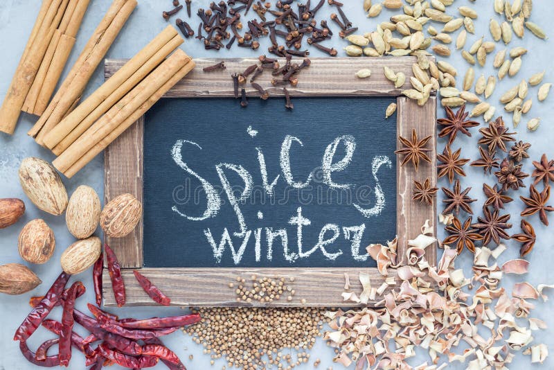 Different Kinds of Aromatic Winter Spices Around Chalk Board on Gray ...