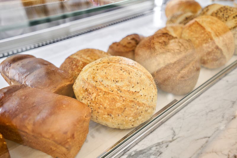 Different Kinds of Bread on the Counter in the Bakery Shop. Fresh Bread ...