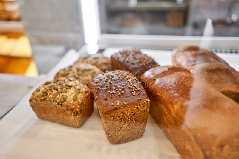 Different Kinds of Bread on the Counter in the Bakery Shop. Fresh Bread ...