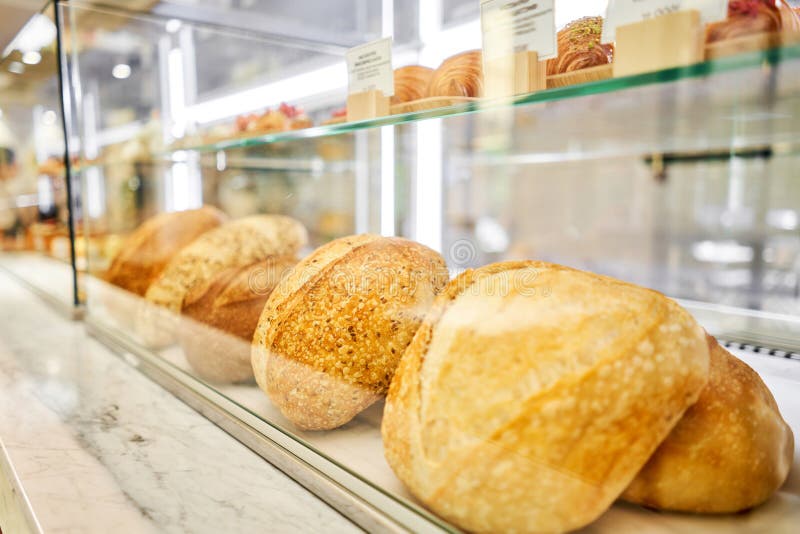 Different Kinds of Bread on the Counter in the Bakery Shop. Fresh Bread ...