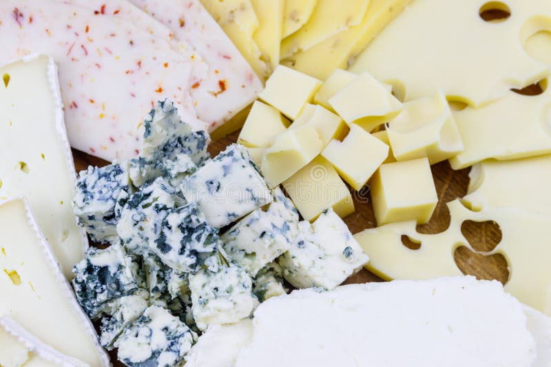 Different Kinds of Cheese on Cutting Board. Close-up Stock Photo ...