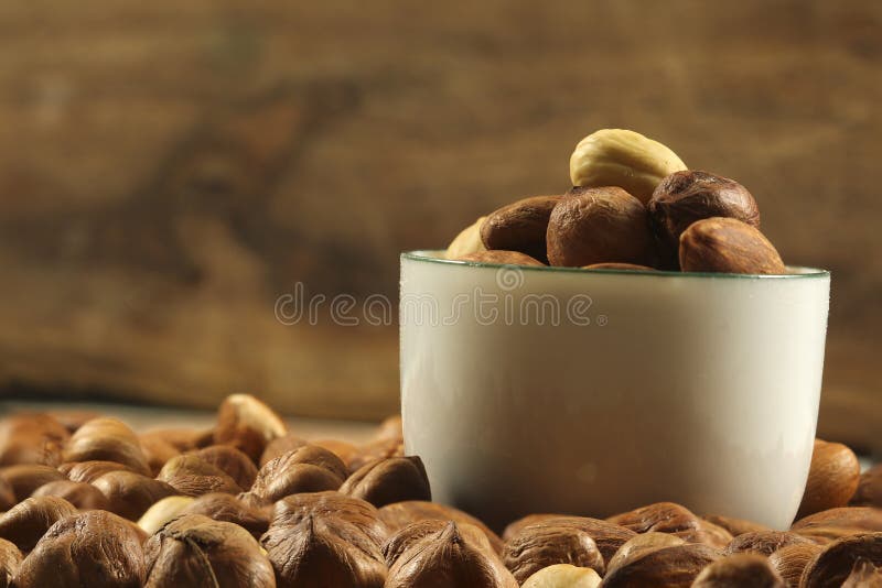 Different Kinds of Nuts in White Cup, Hazelnuts, Almonds on Table ...