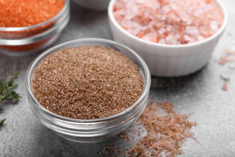 Different Kinds of Salt on Grey Table, Closeup Stock Photo - Image of ...