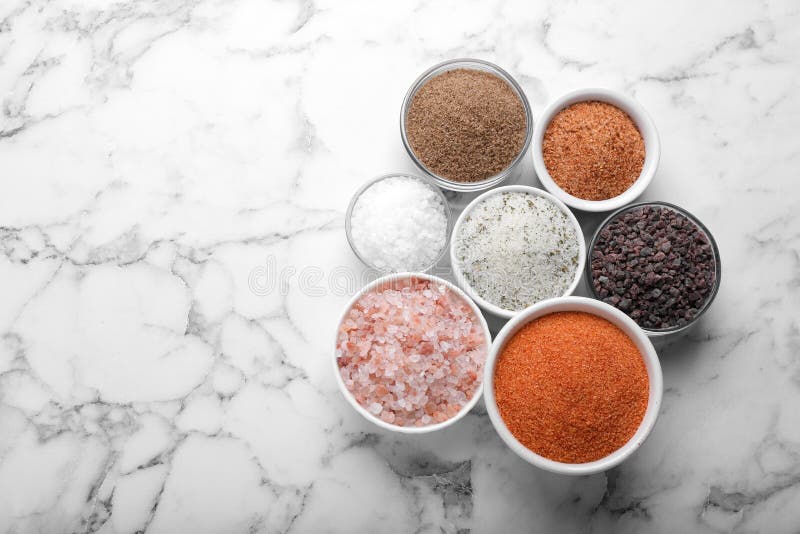 Different Kinds of Salt on White Marble Table, Flat Lay. Space for Text ...