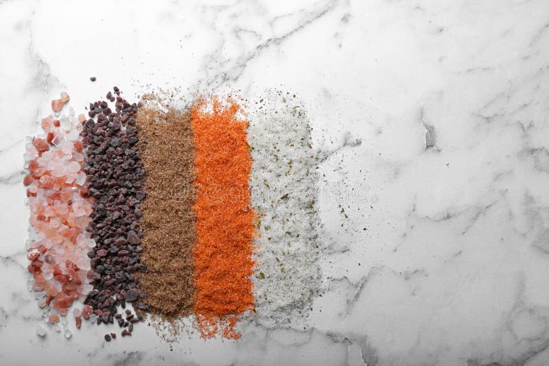 Different Kinds of Salt on White Marble Table, Top View. Space for Text ...