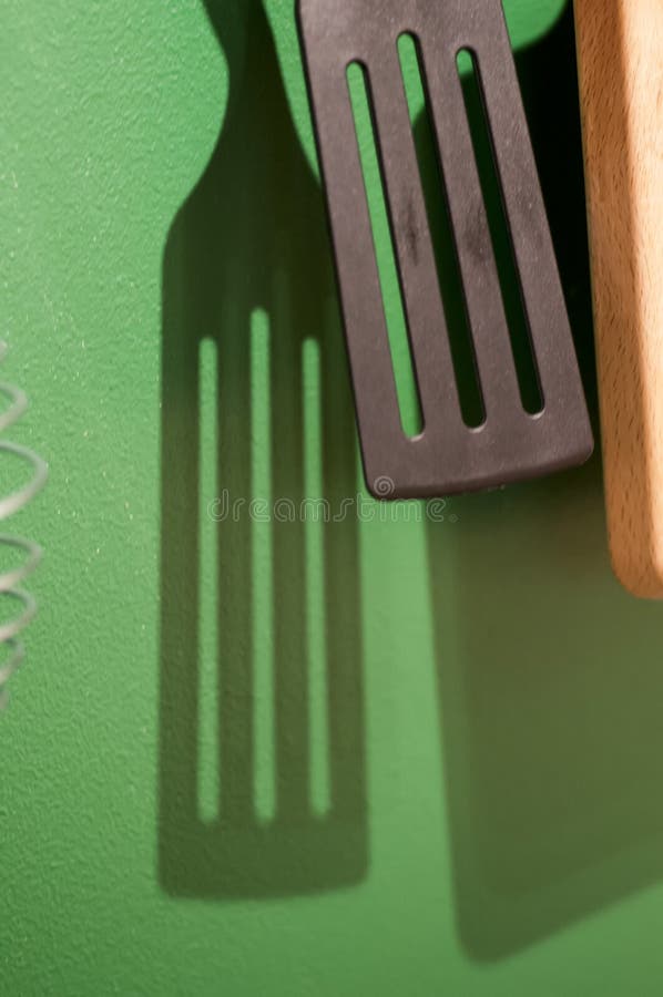 Different Kitchen Tools for Cooking Hanging on the Wall. Stock Photo ...