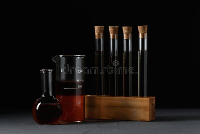 Different Laboratory Glassware with Liquids on Grey Table Stock Photo ...