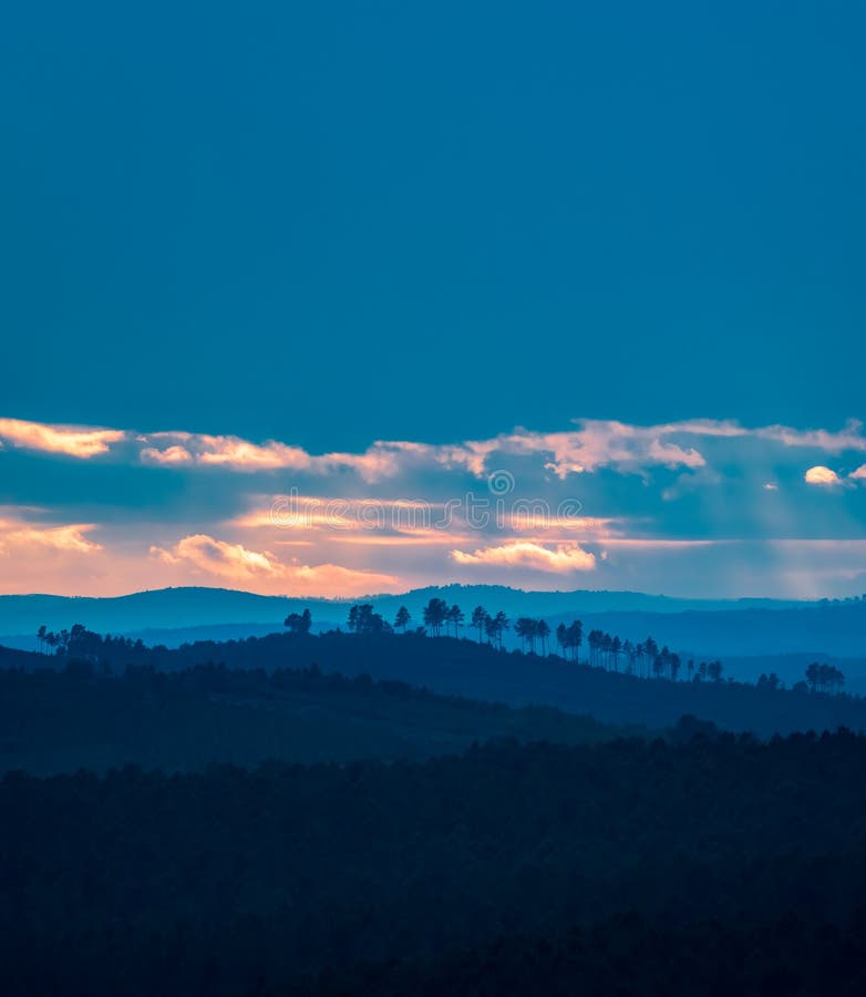 Different Layers of Hills at Sunset with Cloudy Blue Sky Stock Photo ...