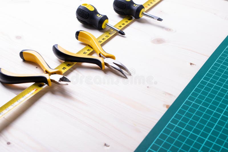 Different Mechanic or Electrician Worker Tools on the Green Checked Mat ...