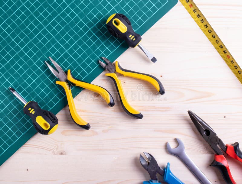 Different Mechanic or Electrician Worker Tools on the Green Checked Mat ...