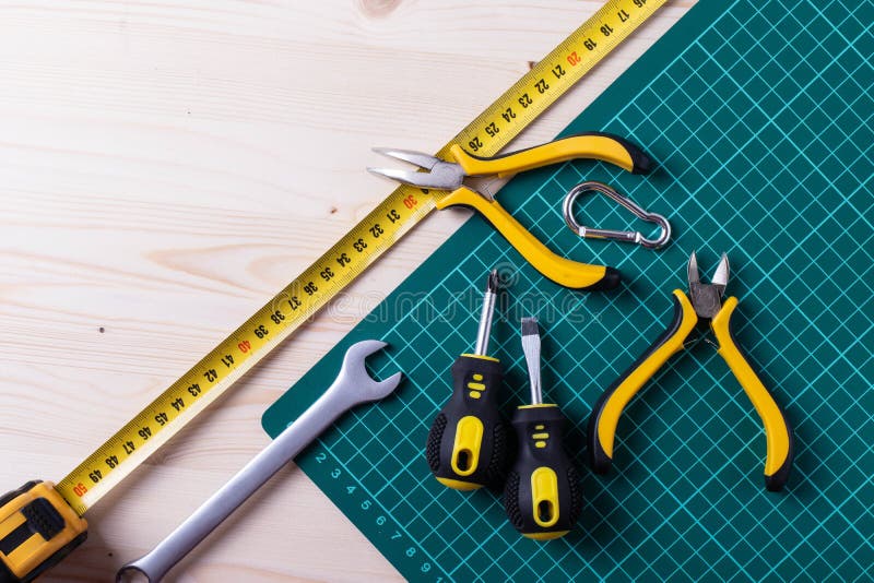 Different Mechanic or Electrician Worker Tools on the Green Checked Mat ...