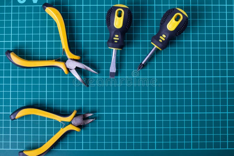 Different Mechanic or Electrician Worker Tools on the Green Checked Mat ...