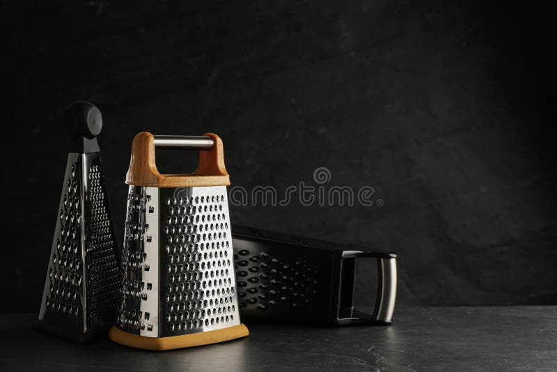Different Modern Graters on Black Table. Space for Text Stock Photo ...