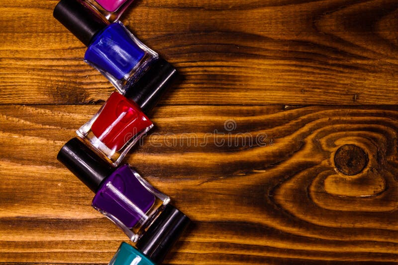 Different Nail Polishes on a Wooden Table. Top View Stock Image - Image ...