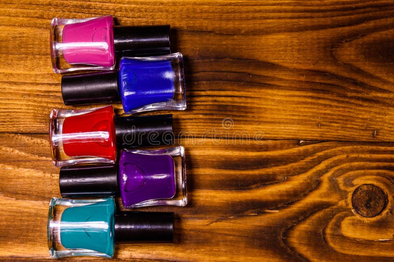 Different Nail Polishes on a Wooden Table. Top View Stock Image - Image ...