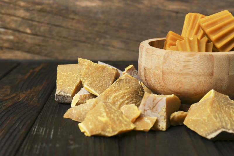 Different Natural Beeswax Blocks on Wooden Table, Closeup. Space for ...