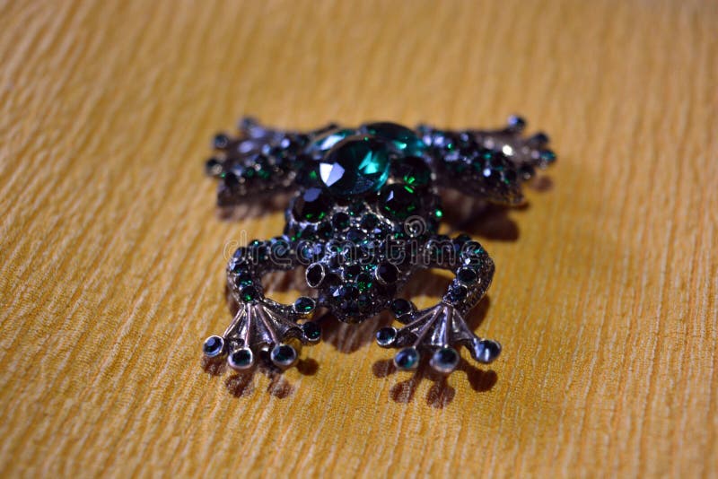 A Beautiful Female Jewelry, a Jewel with Green Stones, a Metal Frog, a ...