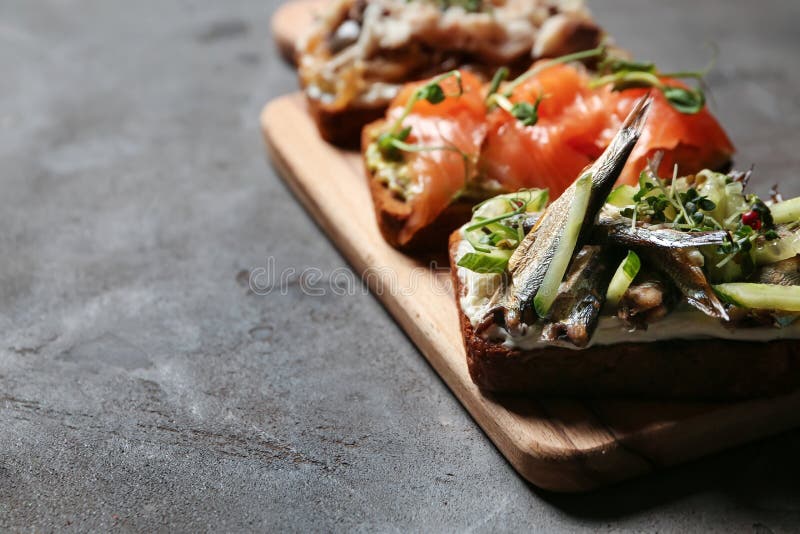Different Open Sandwiches with Fish on Grey Table Stock Photo - Image ...