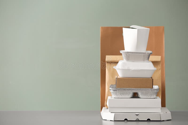 Different Packages on Table Against Color Background. Food Delivery ...