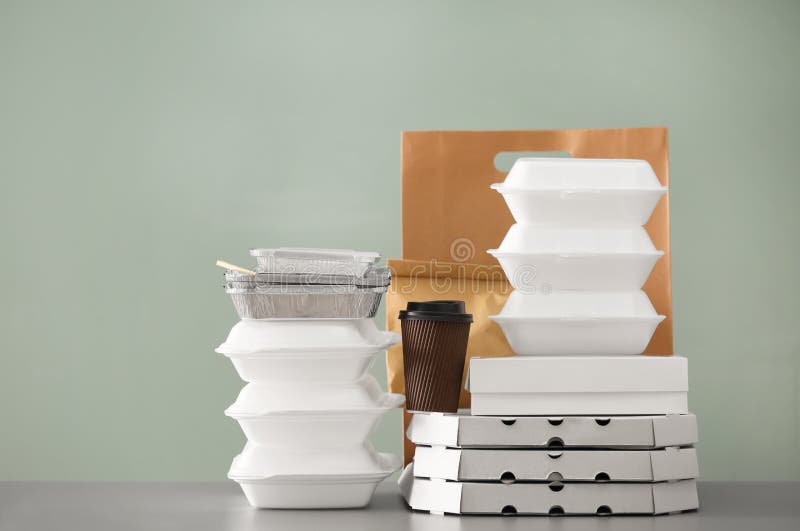 Different Packages on Table Against Color Background. Food Delivery ...
