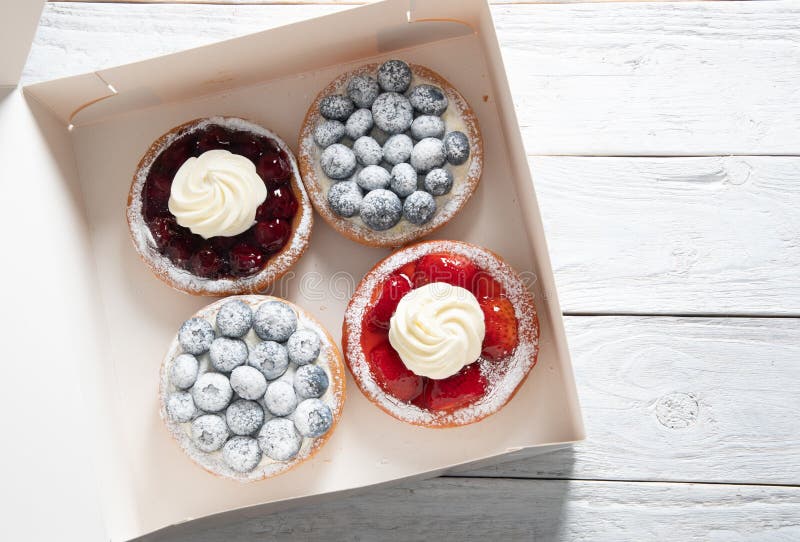 Different Pastries in a Box, Fresh Cakes with Berries and Whipped Cream ...