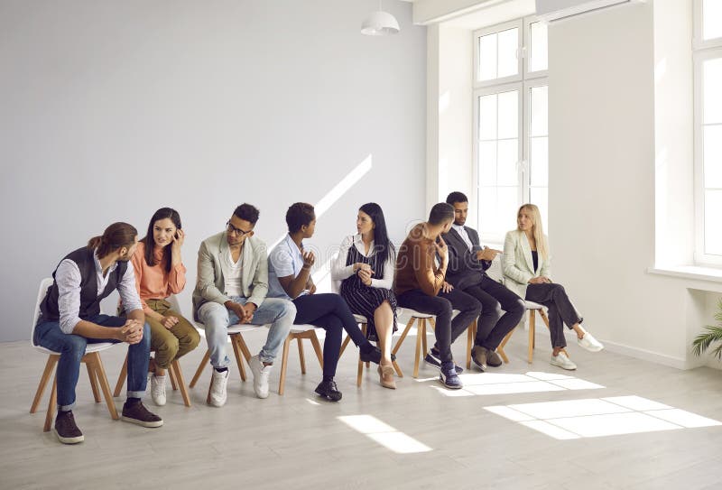Different People Sit in Lines in Row and Communicate in Groups ...