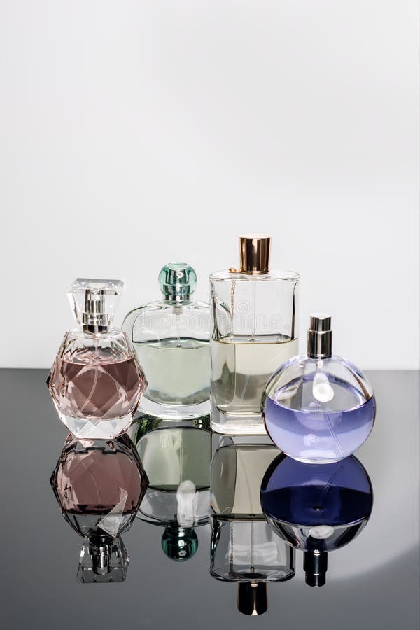 Perfume Bottles with Flowers on Light Background. Perfumery, Cosmetics ...