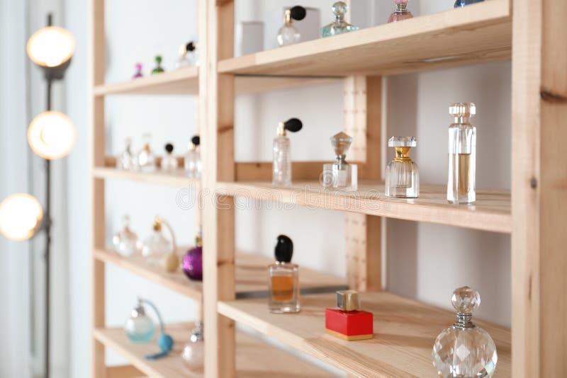 Different Perfume Bottles on Wooden Rack Stock Image - Image of sniff ...