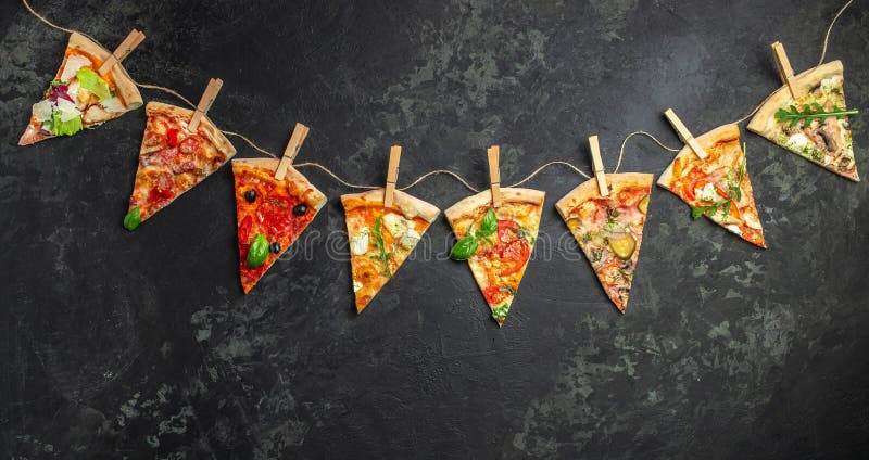 Different Pieces of Pizza on a String with Clothespins Dark Background ...