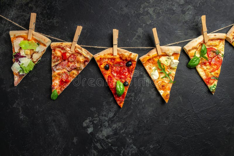 Different Pieces of Pizza on a String with Clothespins Dark Background ...