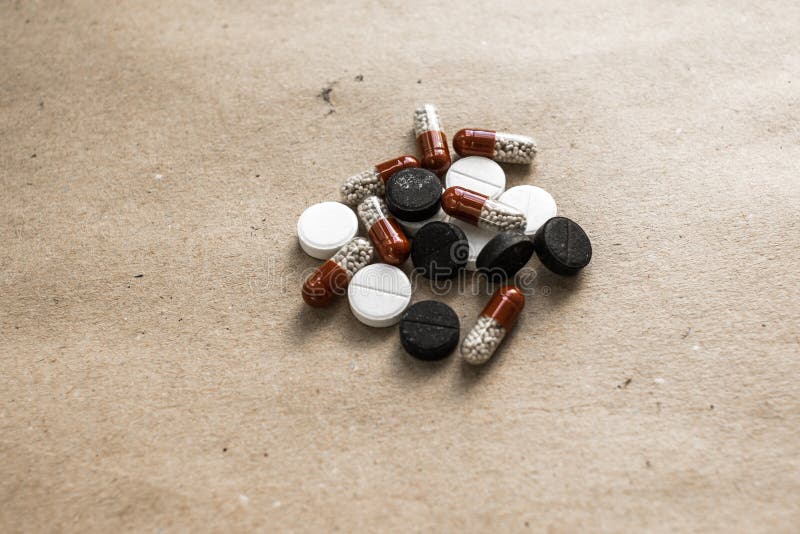 Different pills on paper stock photo. Image of closeup - 97293134