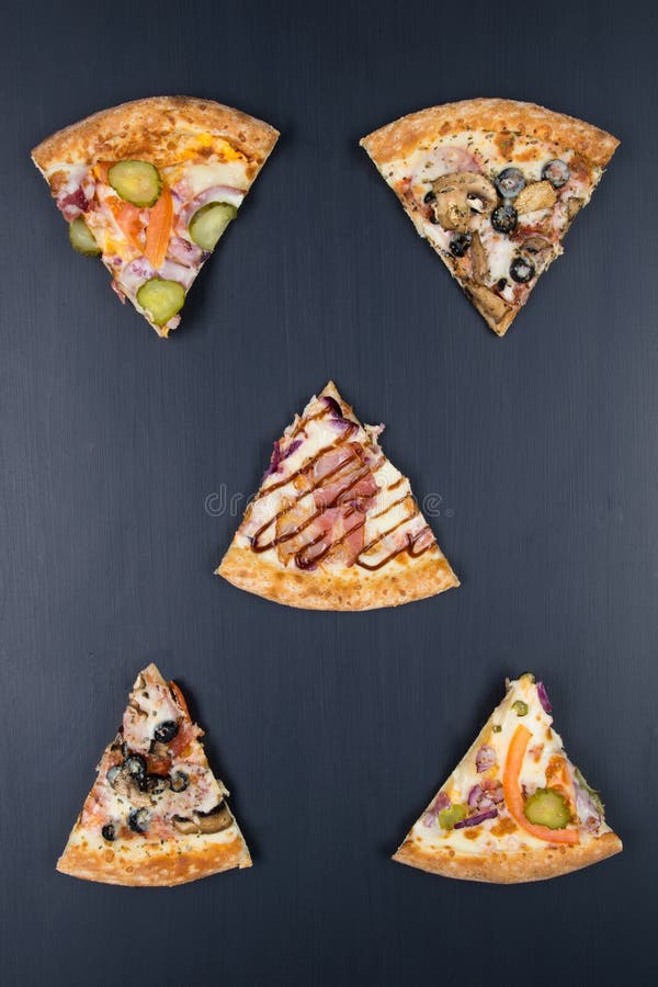Different Pizza Pieces Arranged on a Black Stock Photo - Image of ...