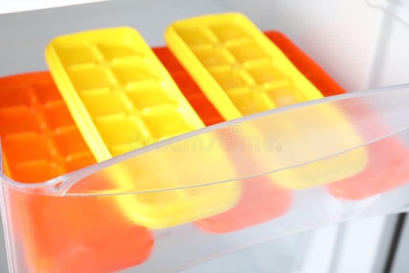 Different Plastic Ice Cube Trays in Fridge Stock Photo - Image of piece ...