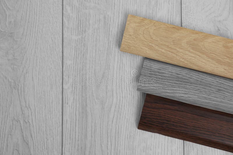 Different Plinths on Laminated Floor in Room, Flat Lay. Space for Text ...