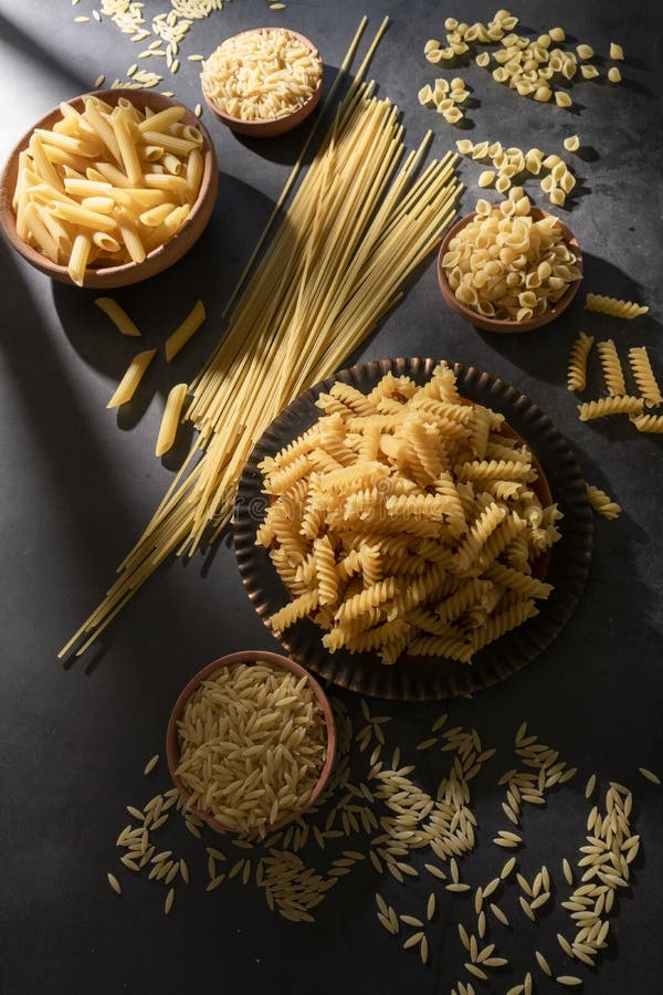 Different Raw Pasta Types in Plates, Food Ingredients Backdrop Stock ...