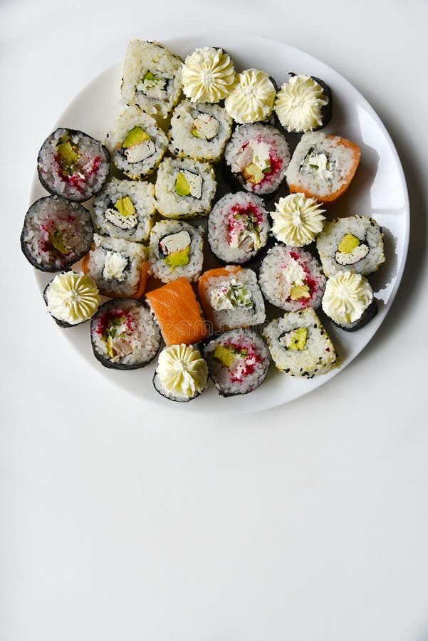 Different Rice Rolls with Fish and Cucumber on a White Plate Stock ...
