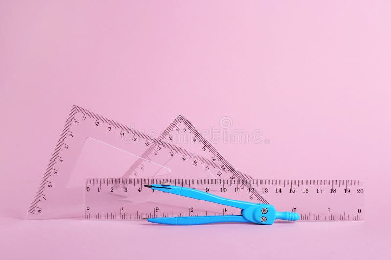 Different Rulers and Compass on Pink Background Stock Photo - Image of ...