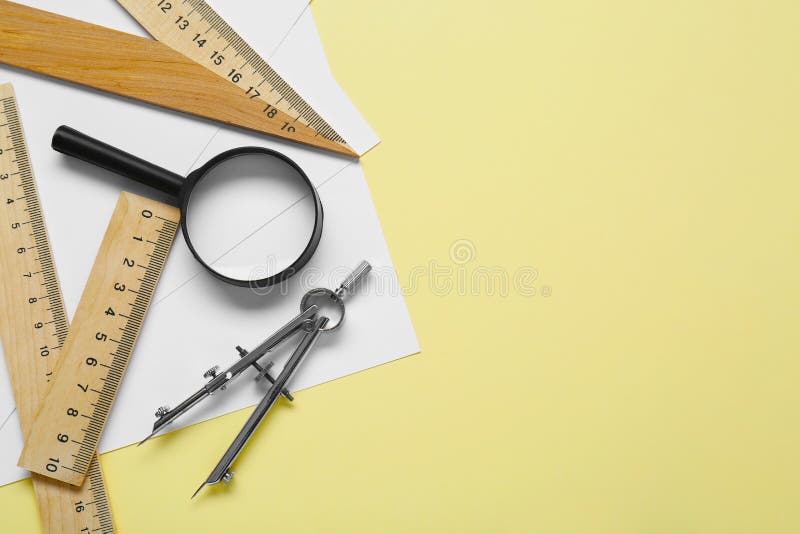 Different Rulers, Pencil, and Compass on Yellow Background. Space for ...