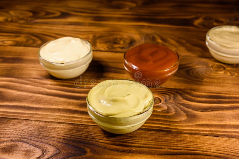 Different Sauces in Glass Bowls on Wooden Table Stock Photo - Image of ...