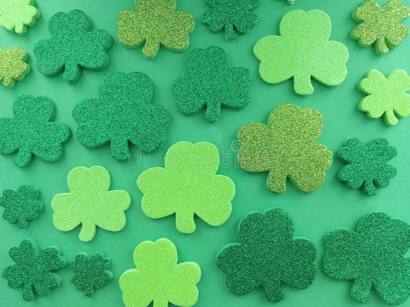 Different Shades and Sizes of Green Glitter Shamrocks on a Green ...