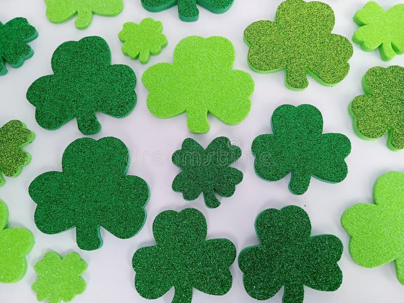 Different Shades and Sizes of Green Glitter Shamrocks on a White ...