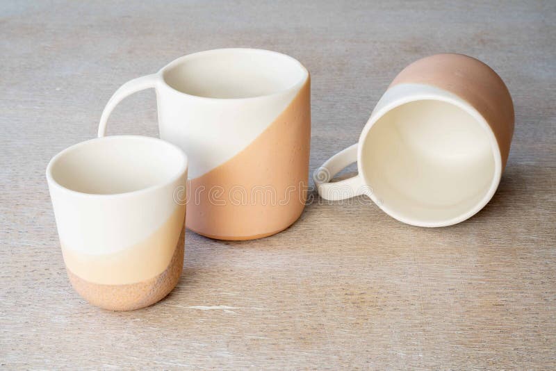 Sizes of Luxury White and Brown Ceramic Dipped Mugs on Marble ...